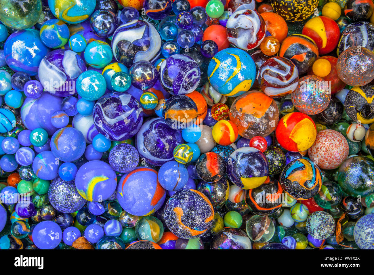 Glass marbles of different sizes in a color pattern as concept for ...