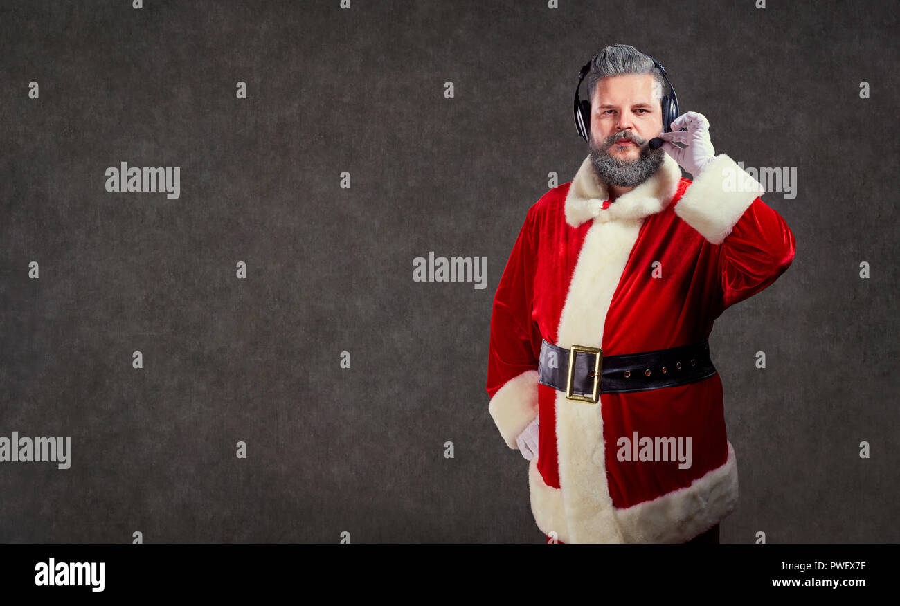 Santa Claus in a headset call center operator on a copyspace background ...