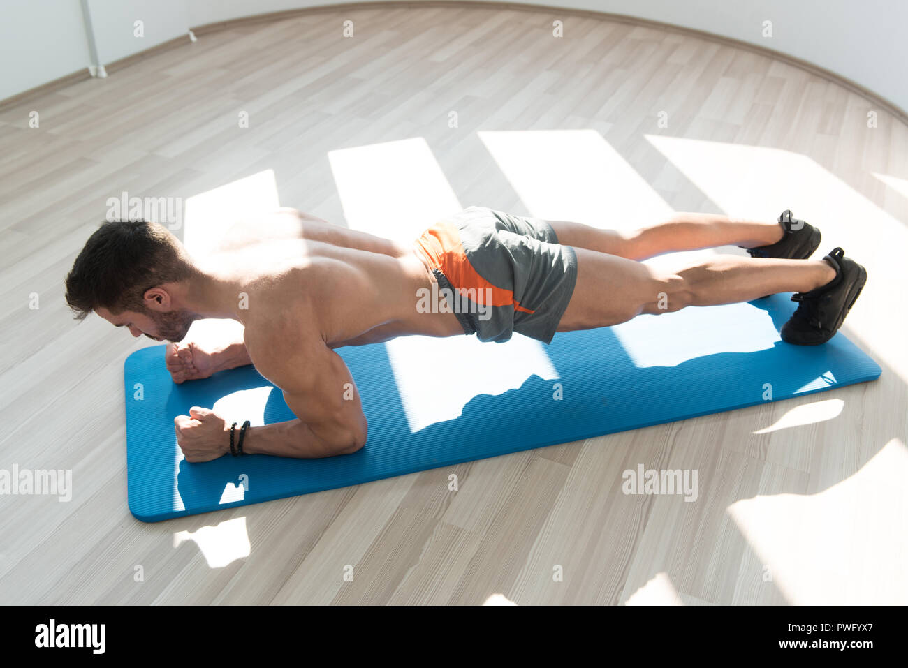 Young Man Athlete Doing Abs Exercise Elbow Plank As Part Of ...