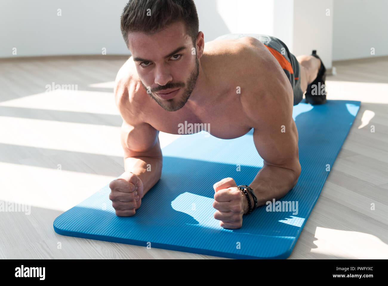 Attractive muscular male bodybuilder leaning hi-res stock photography ...