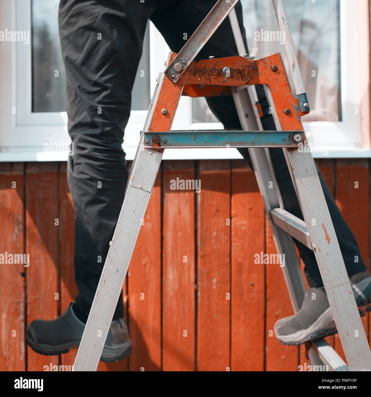 Balancing on ladder hi-res stock photography and images - Alamy