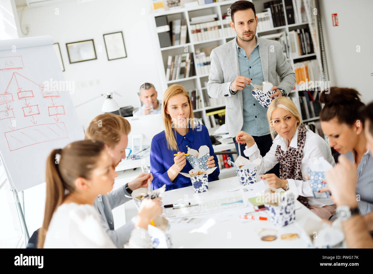 Business people eating in office Stock Photo - Alamy