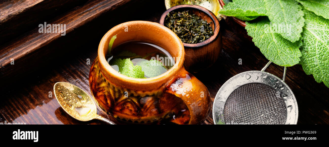 Brewed delicious herbal tea with sage on retro background Stock Photo ...