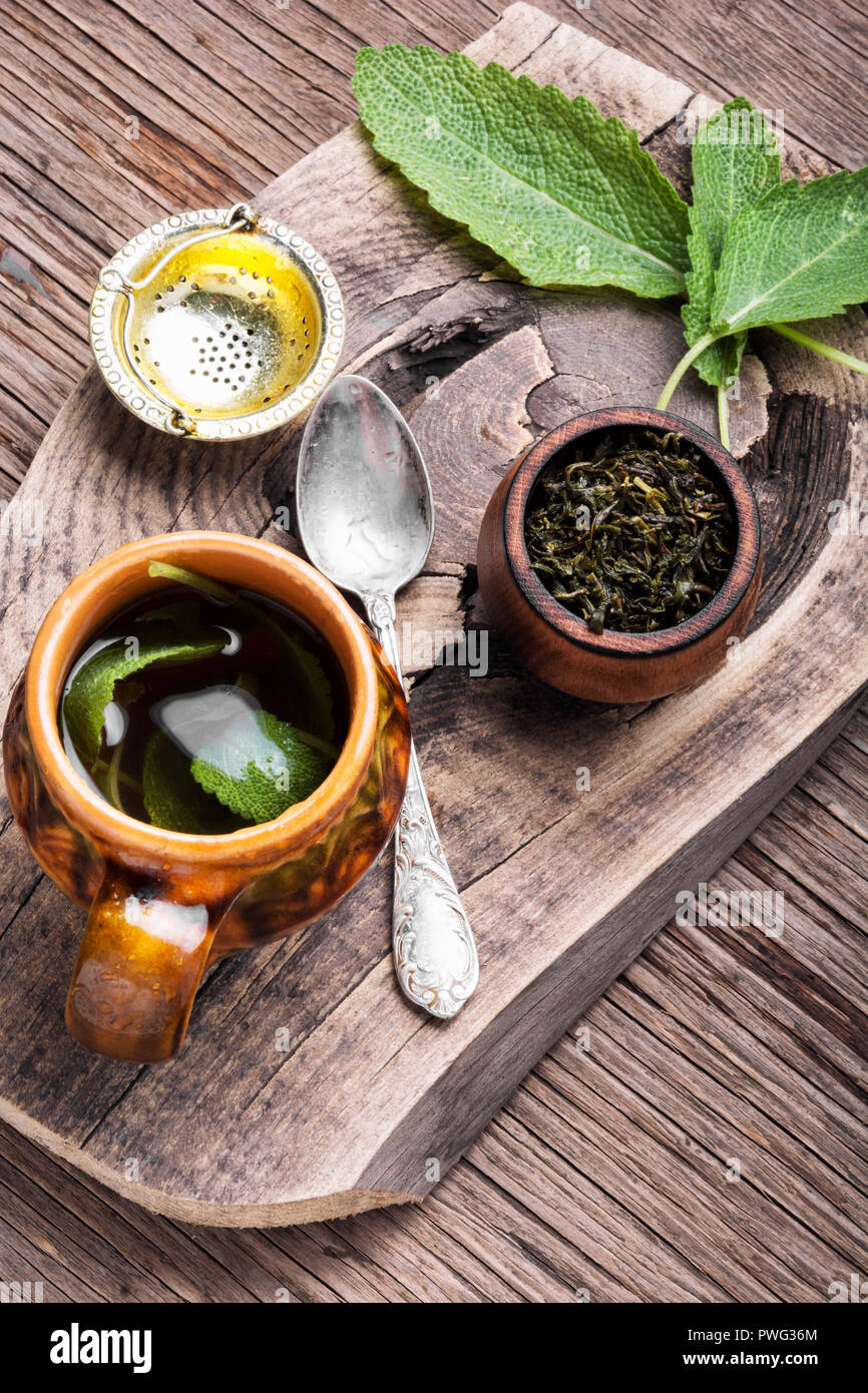 Brewed delicious herbal tea with sage on retro background.Herbal tea ...