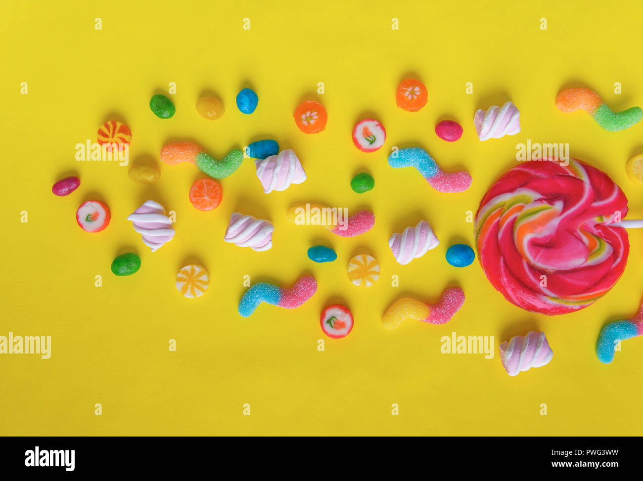 Candy caramel on a yellow background. Celebration Stock Photo - Alamy