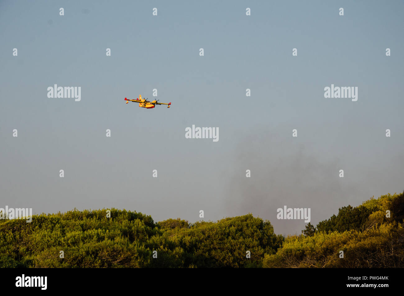 firefighting aircraft, canadair in action, throwing water into the fire ...