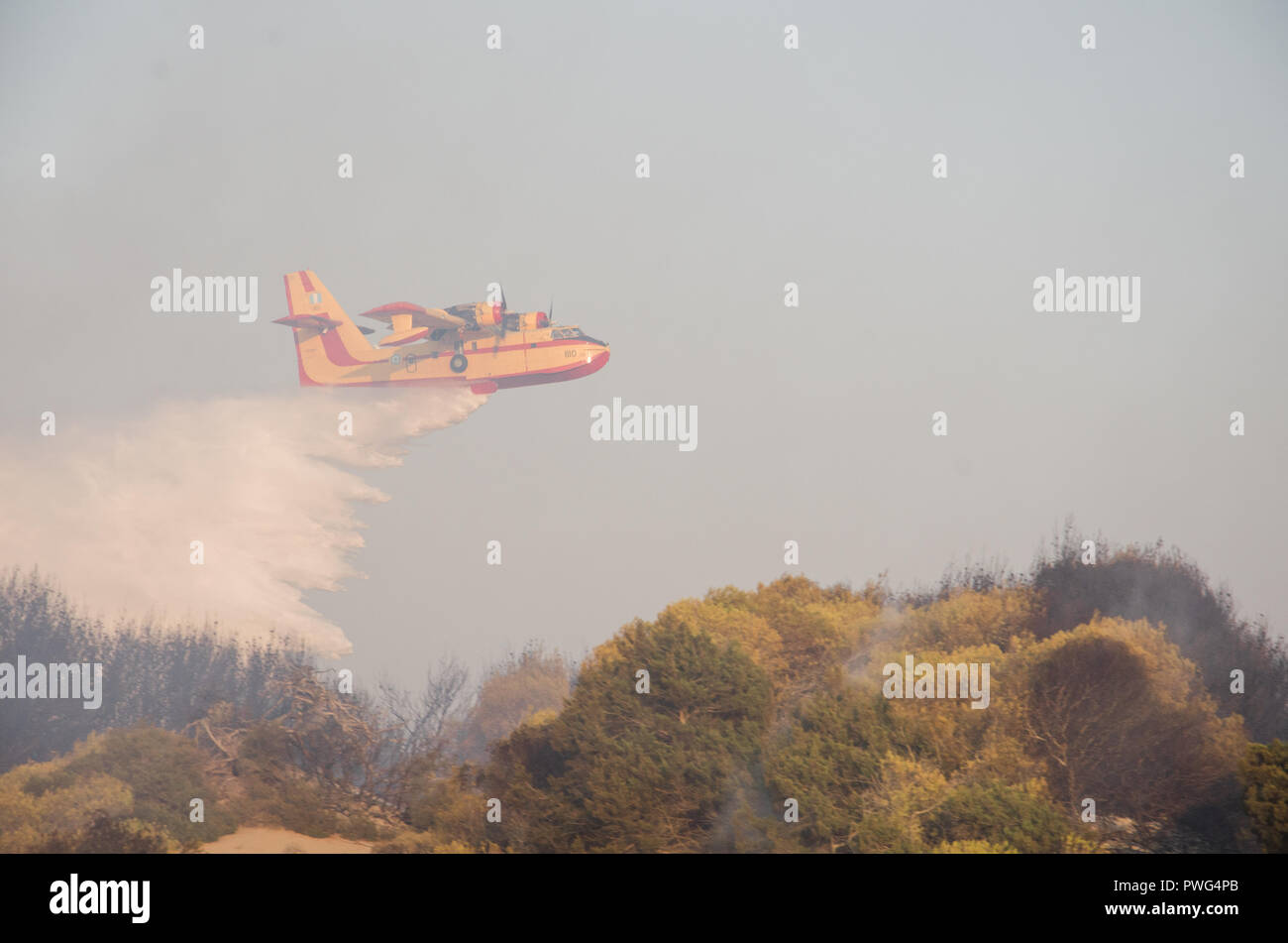 firefighting aircraft, canadair in action, throwing water into the fire ...