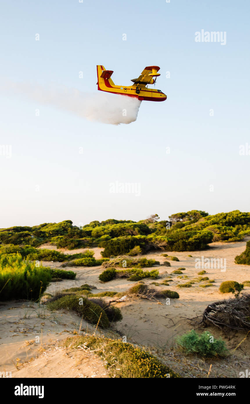 firefighting aircraft, canadair in action, throwing water into the fire ...