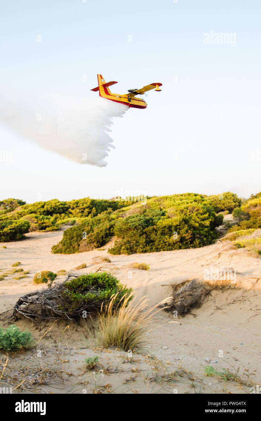 firefighting aircraft, canadair in action, throwing water into the fire ...