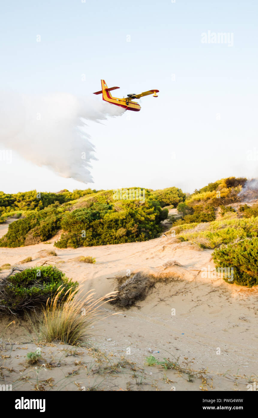 firefighting aircraft, canadair in action, throwing water into the fire ...