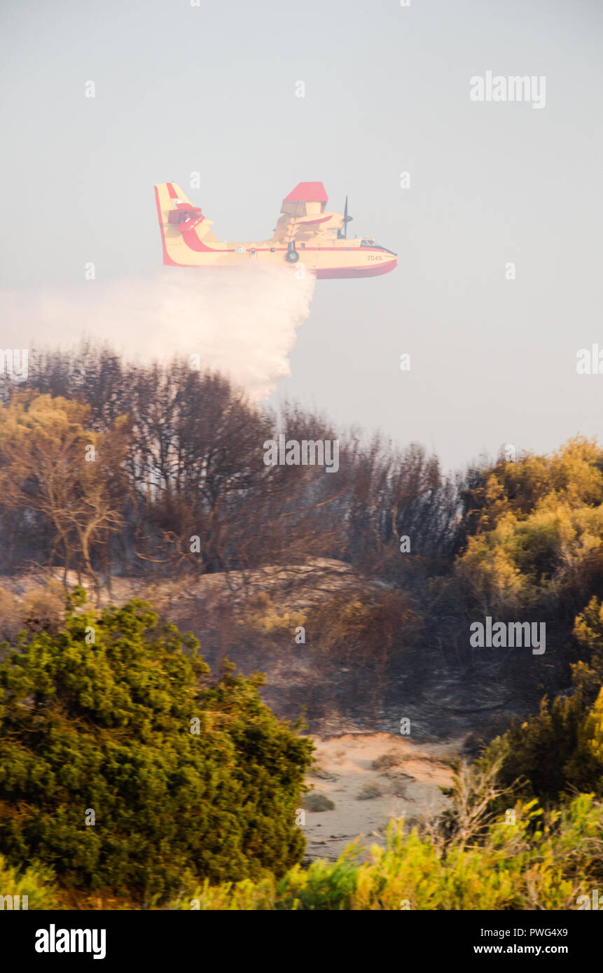 firefighting aircraft, canadair in action, throwing water into the fire ...
