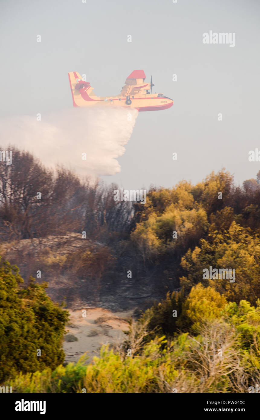 firefighting aircraft, canadair in action, throwing water into the fire ...