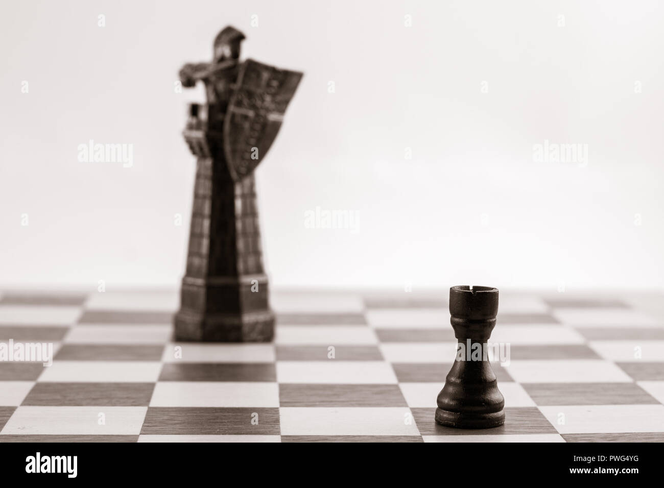 Classic black rook and the same piece in the form of medieval figure on ...