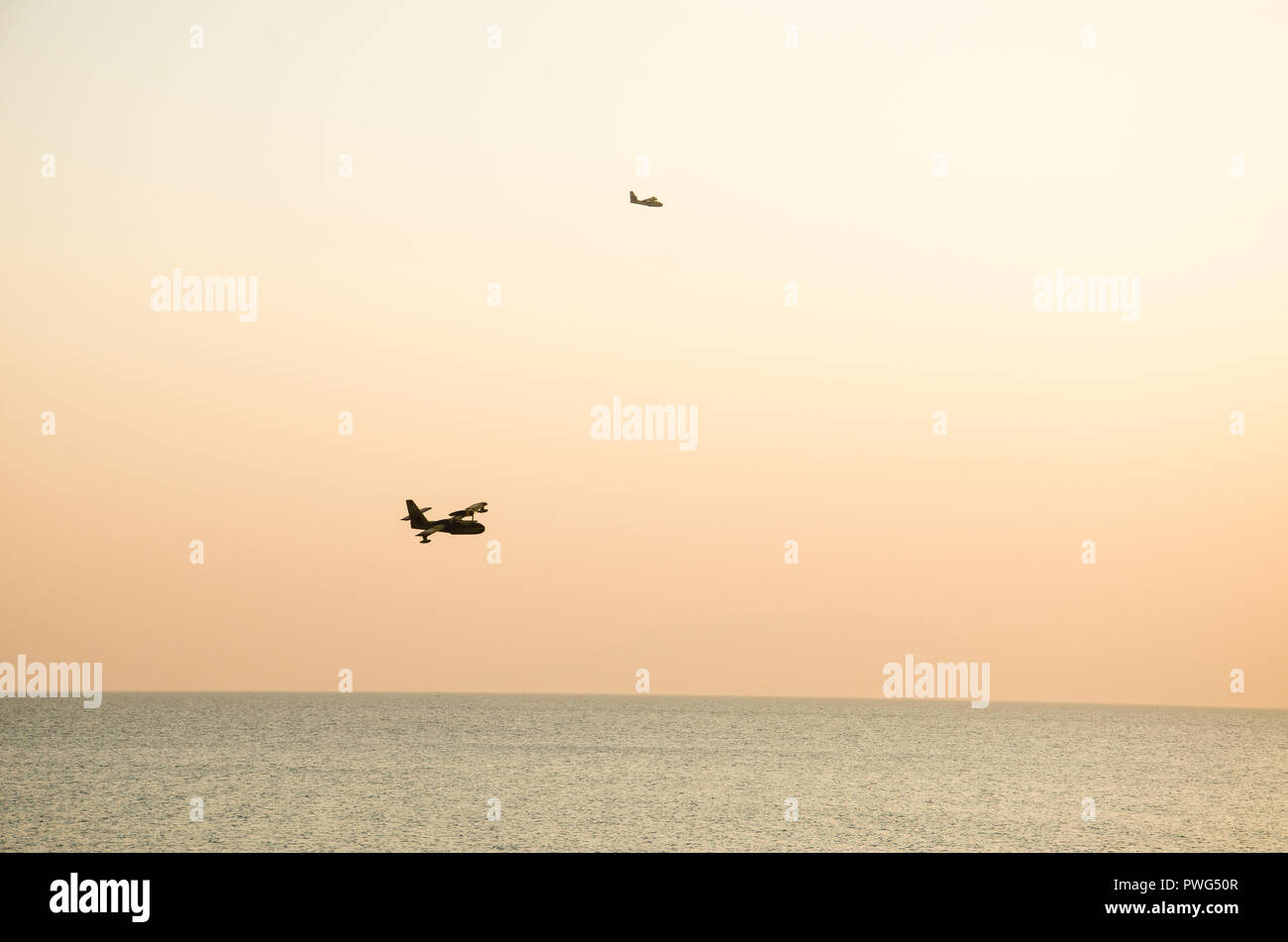 firefighting aircraft, canadair in action, throwing water into the fire ...