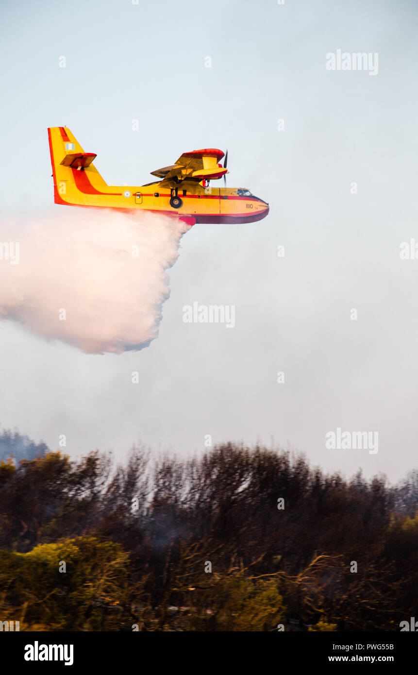 firefighting aircraft, canadair in action, throwing water into the fire ...