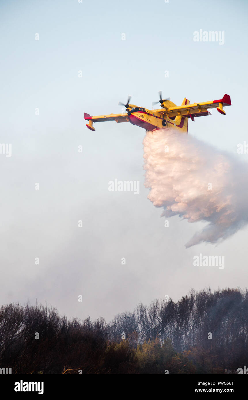 firefighting aircraft, canadair in action, throwing water into the fire ...