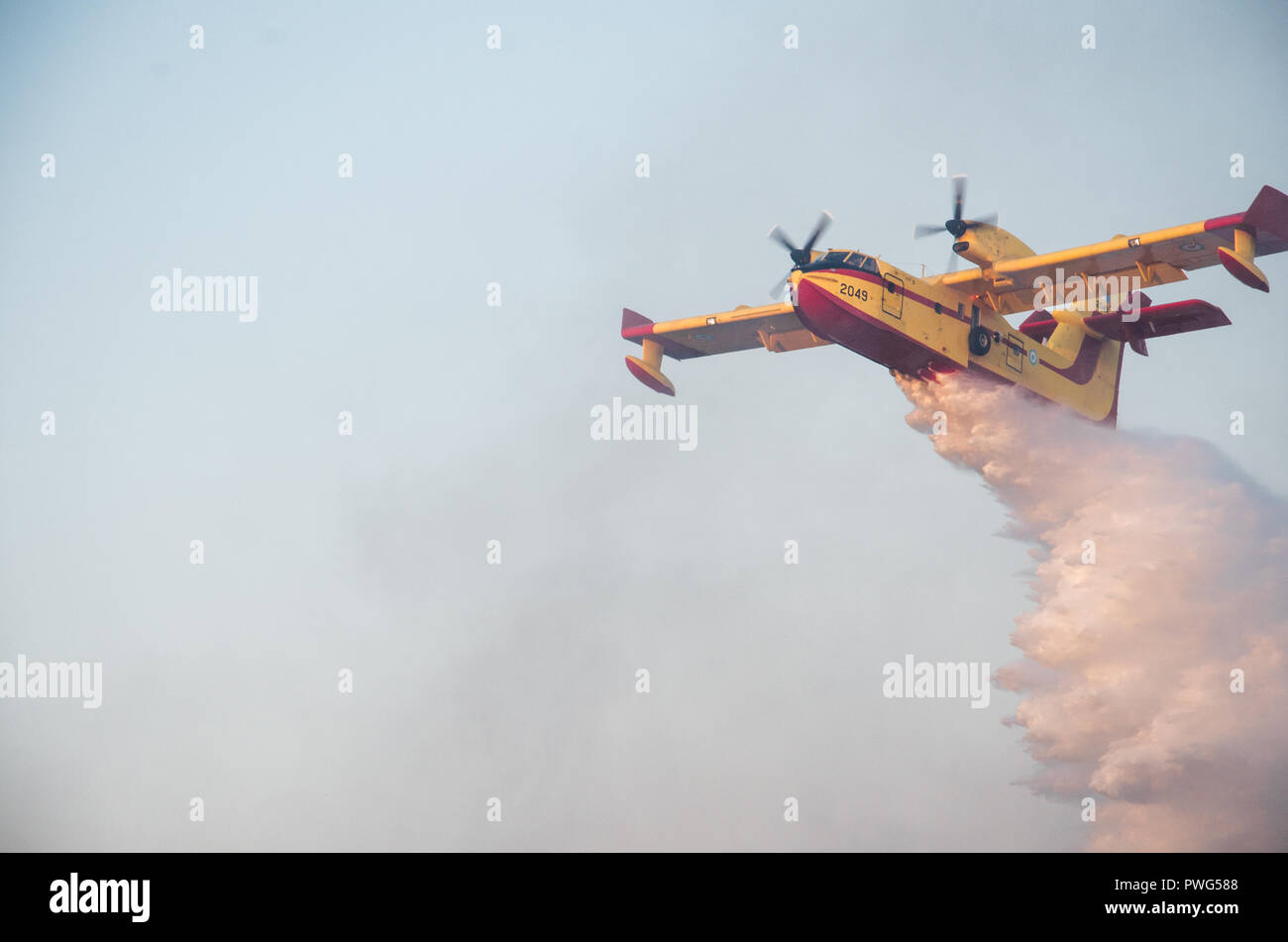 firefighting aircraft, canadair in action, throwing water into the fire ...