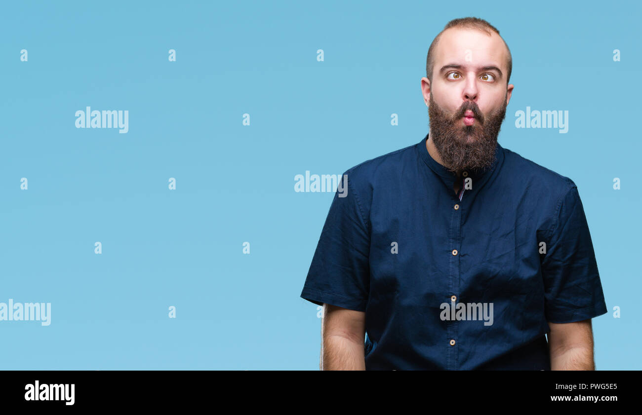 Young caucasian hipster man over isolated background making fish face ...