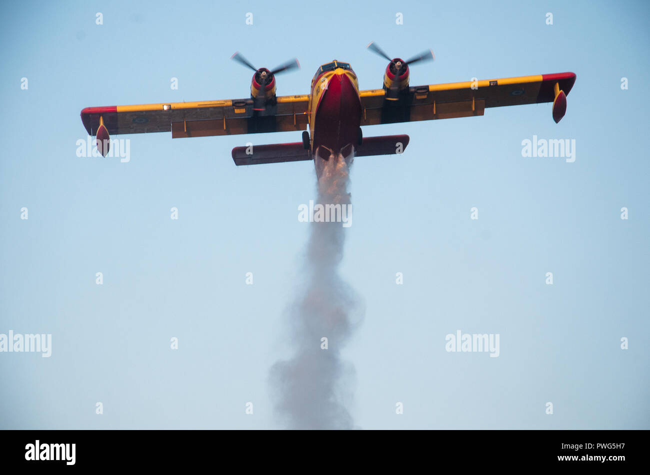 firefighting aircraft, canadair in action, throwing water into the fire ...