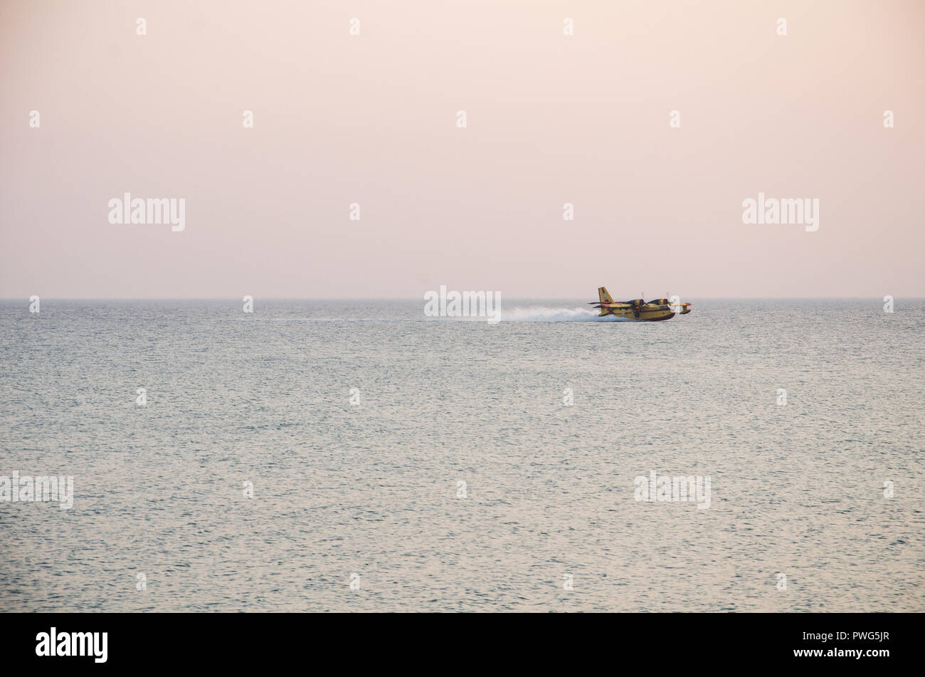 firefighting aircraft, canadair in action, throwing water into the fire ...