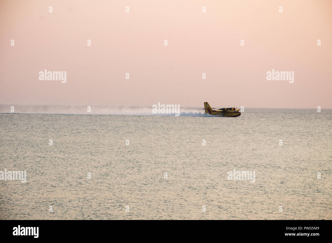 firefighting aircraft, canadair in action, throwing water into the fire ...