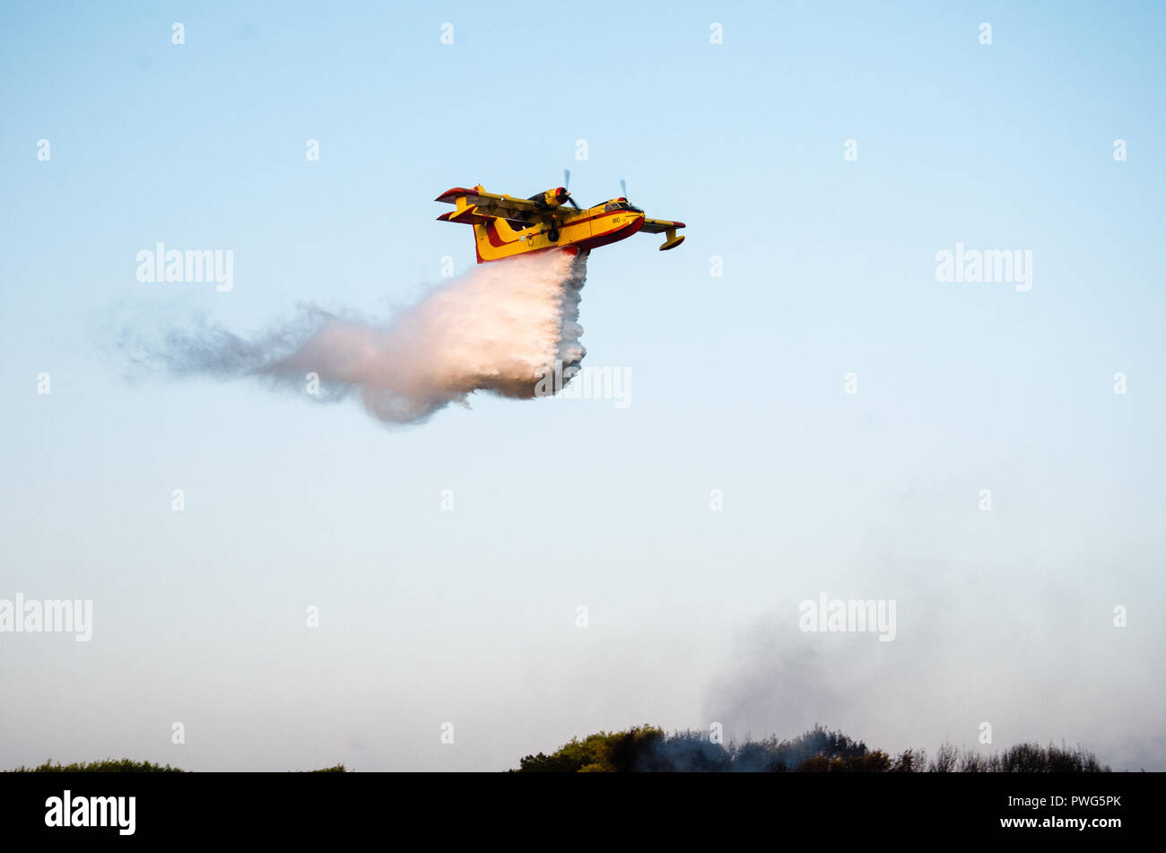 firefighting aircraft, canadair in action, throwing water into the fire ...