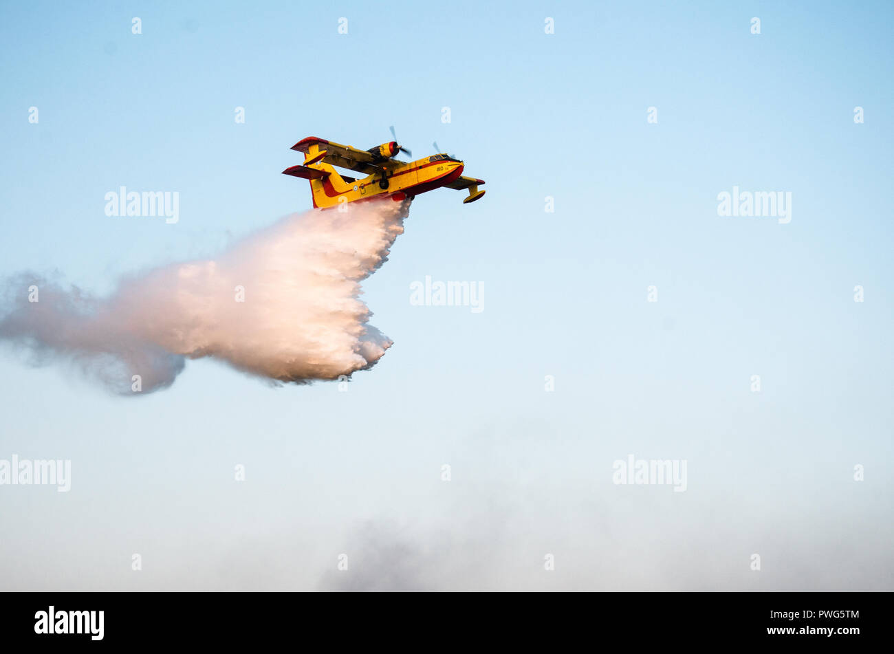 firefighting aircraft, canadair in action, throwing water into the fire ...