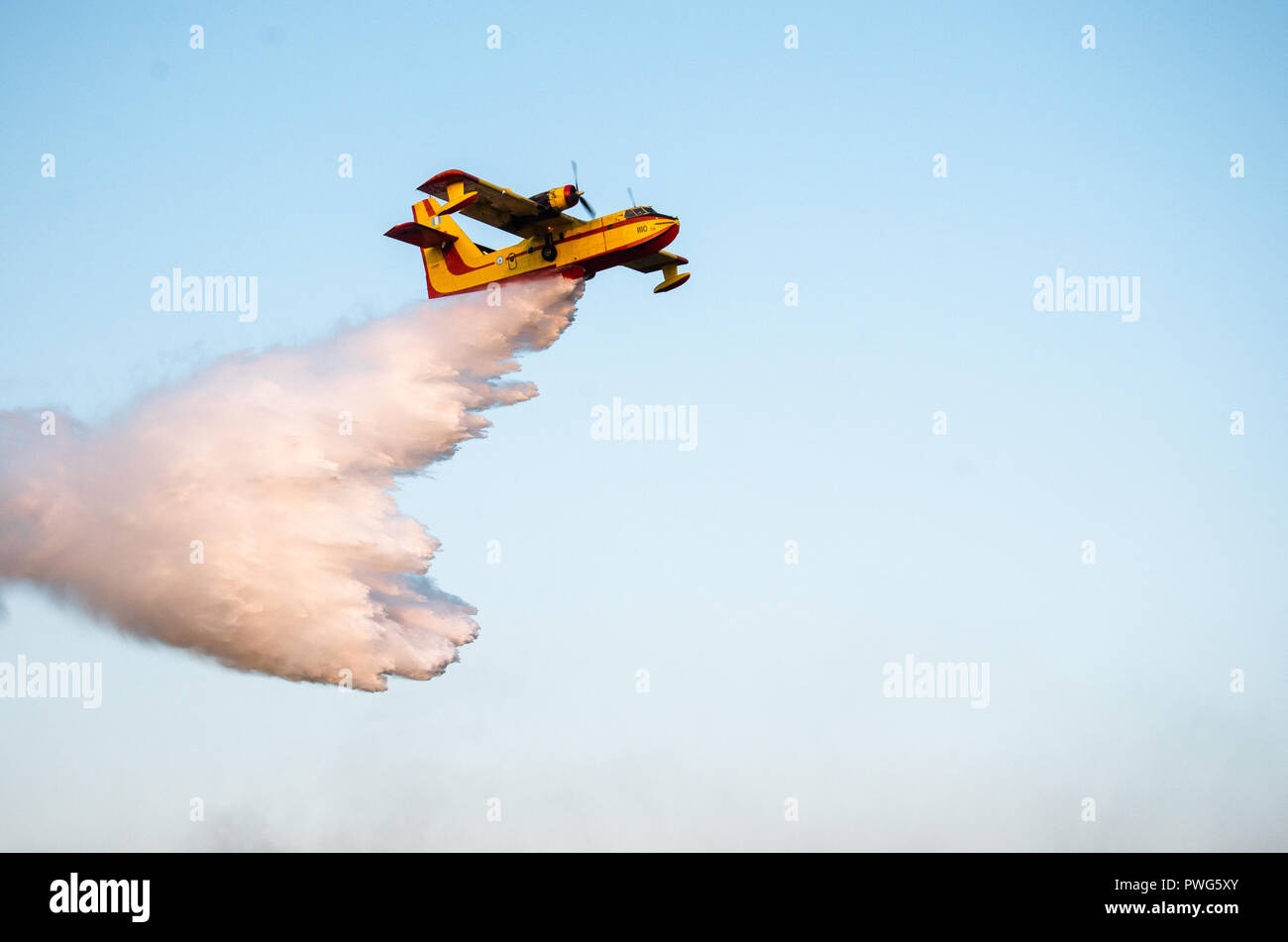 firefighting aircraft, canadair in action, throwing water into the fire ...
