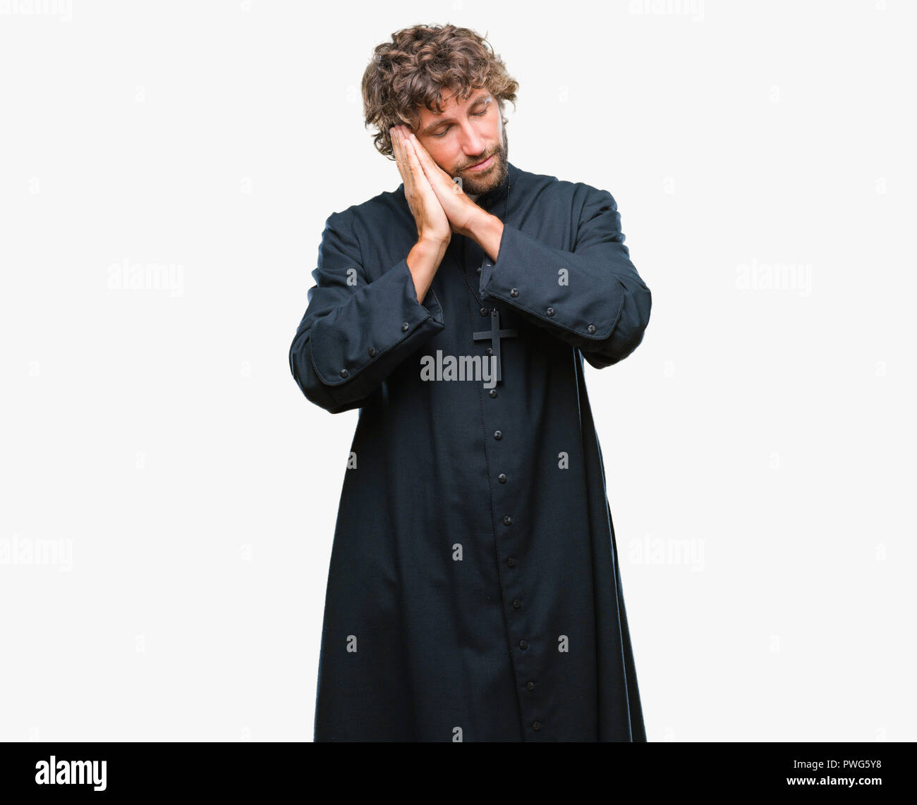 Handsome hispanic catholic priest man over isolated background sleeping ...