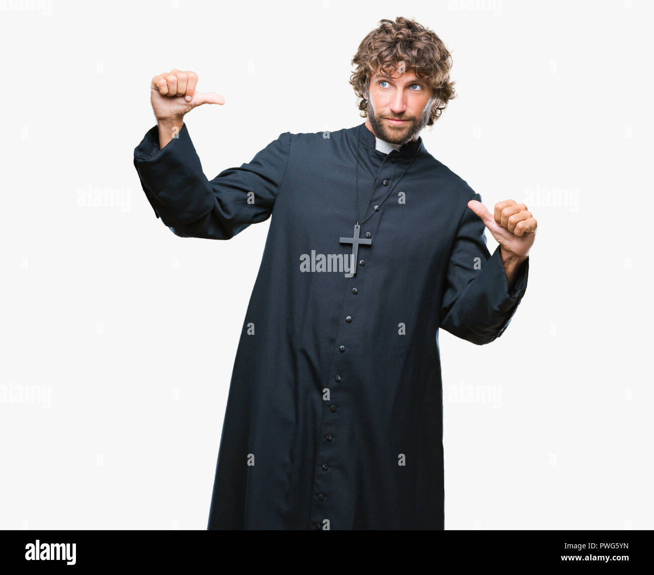 Handsome hispanic catholic priest man over isolated background looking ...