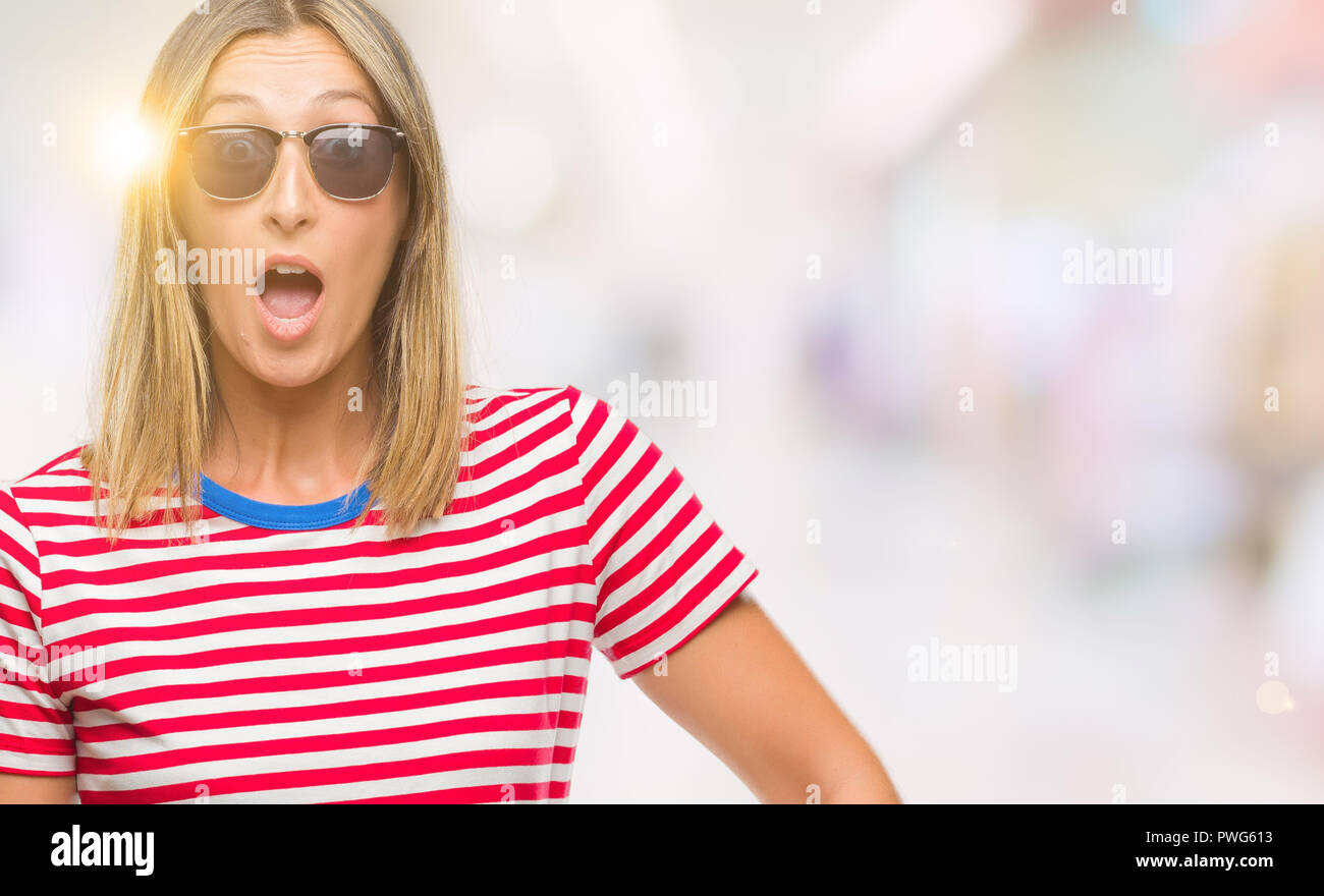 Young beautiful woman holding soccer football ball over isolated ...