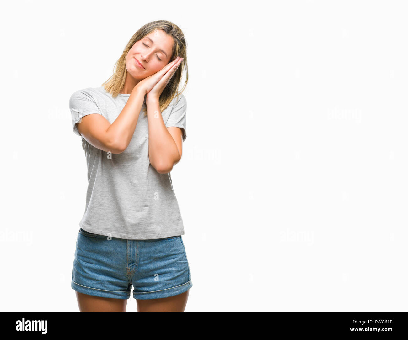 Young beautiful woman over isolated background sleeping tired dreaming ...