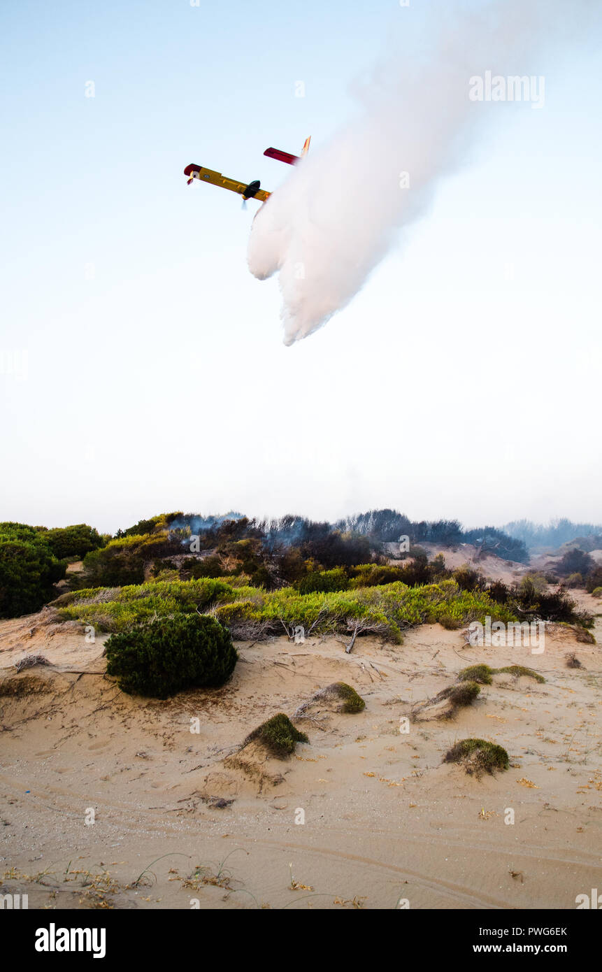 firefighting aircraft, canadair in action, throwing water into the fire ...
