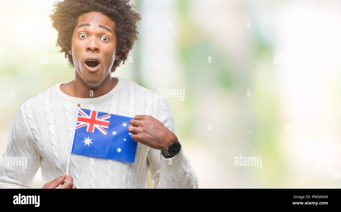Afro american man flag of Australia over isolated background scared in ...