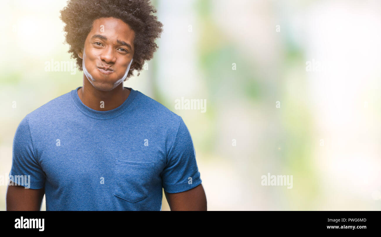 Afro american man over isolated background puffing cheeks with funny ...