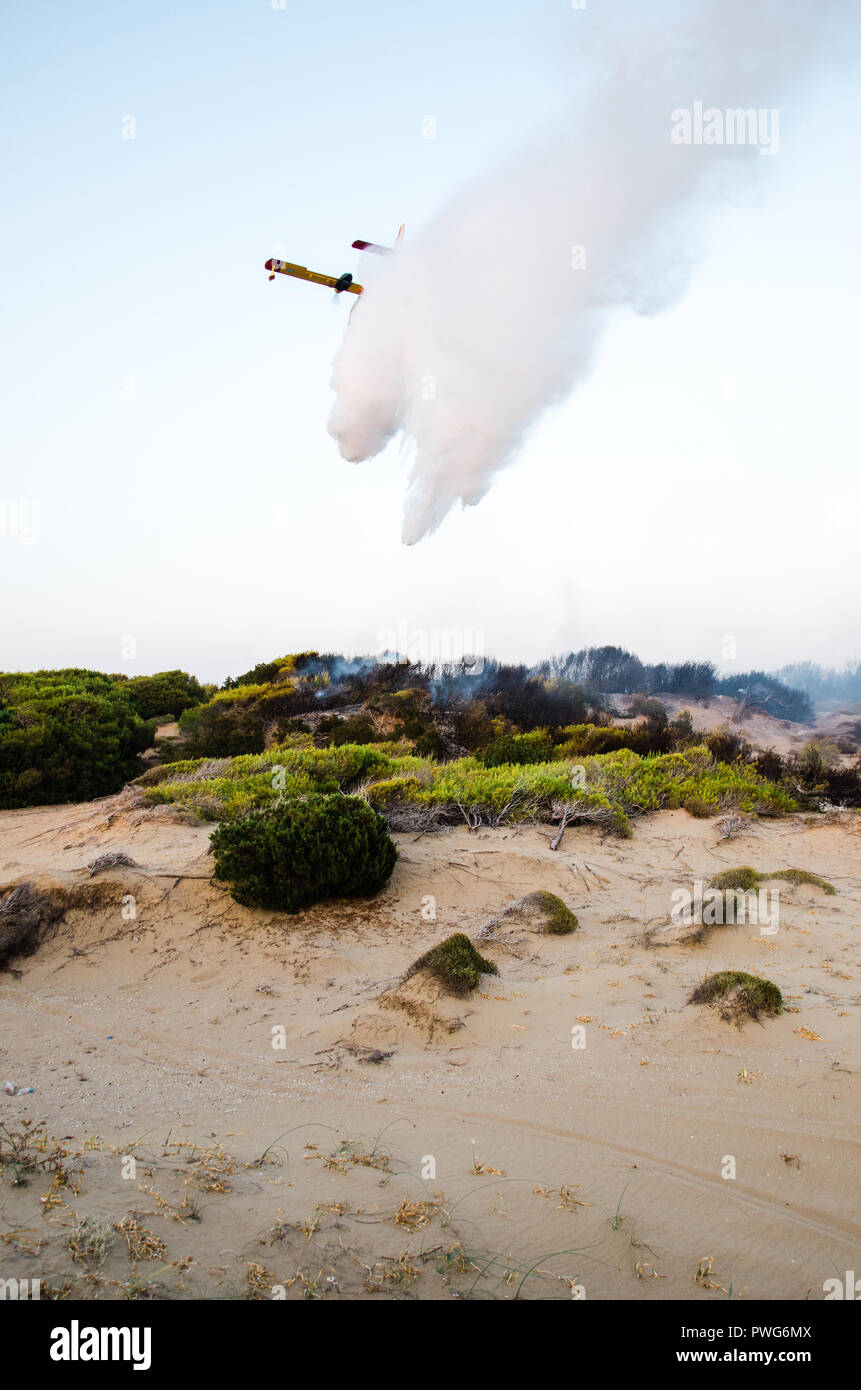 firefighting aircraft, canadair in action, throwing water into the fire ...
