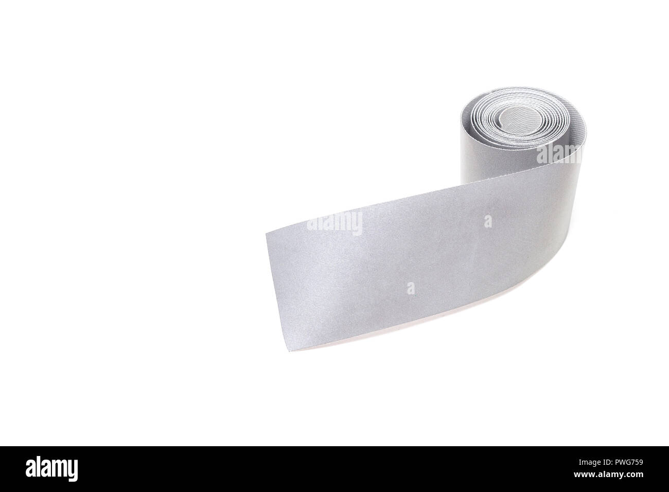 A roll of reflective tape on a white background, close-up, isolate ...