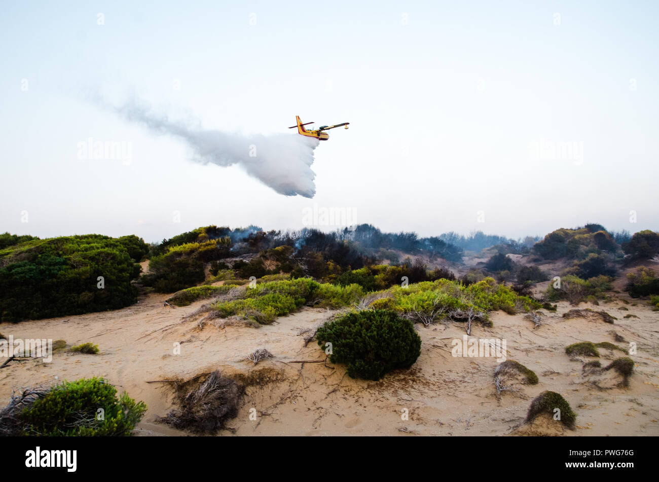 firefighting aircraft, canadair in action, throwing water into the fire ...