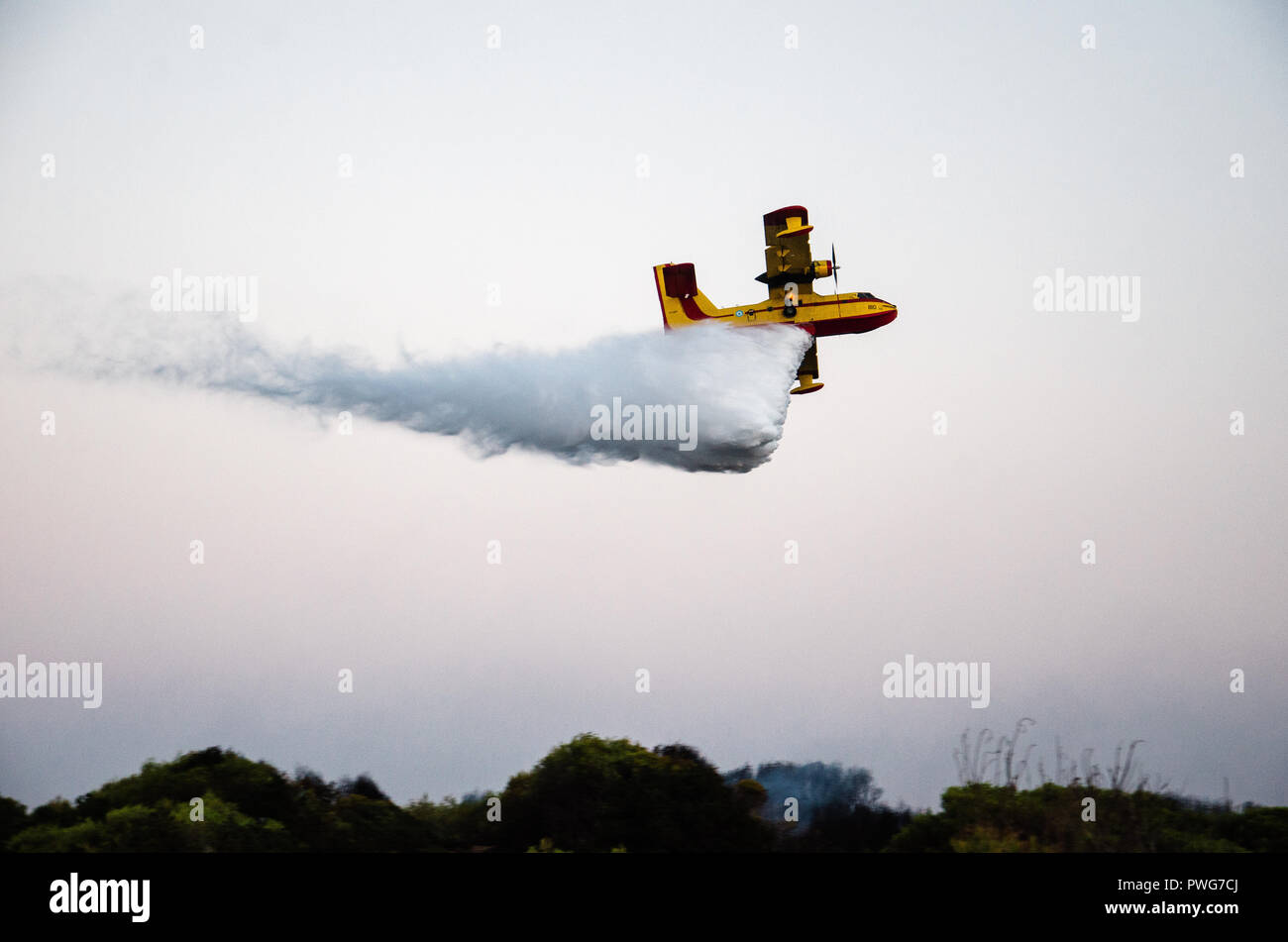 firefighting aircraft, canadair in action, throwing water into the fire ...