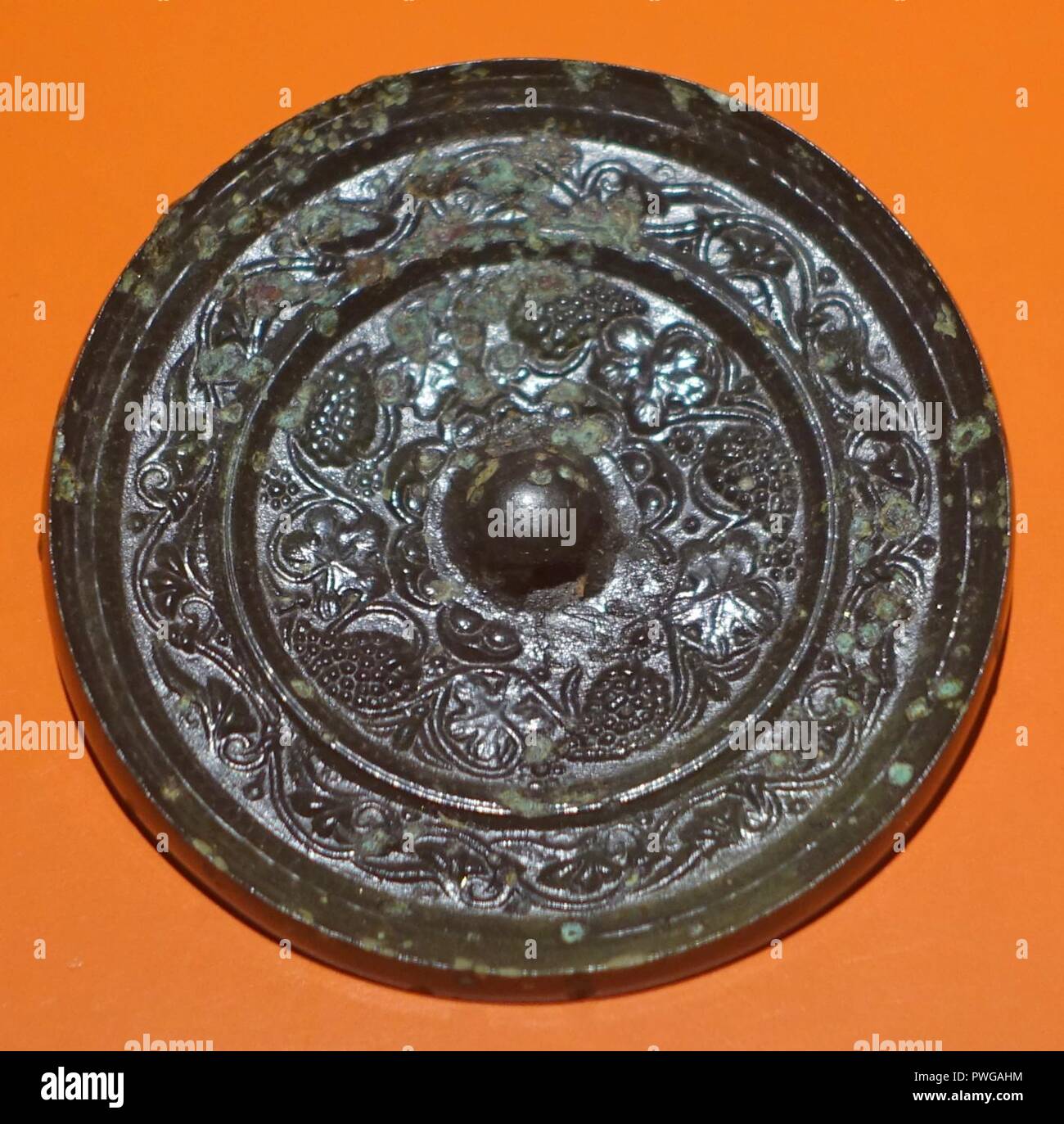 Bronze mirror with grapevine and interlock branch motif, Tang dynasty ...