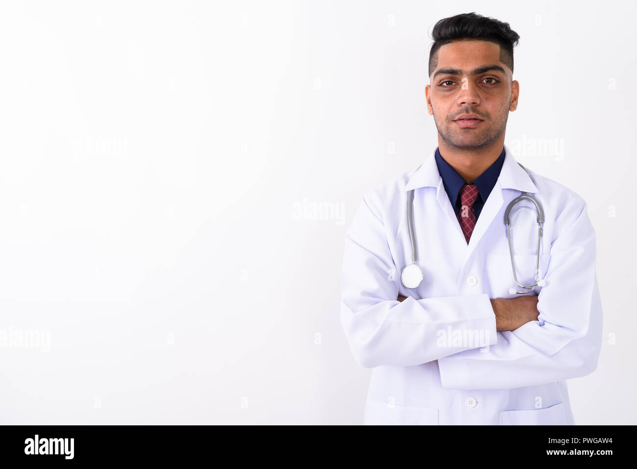 Young Indian man doctor against white background Stock Photo - Alamy