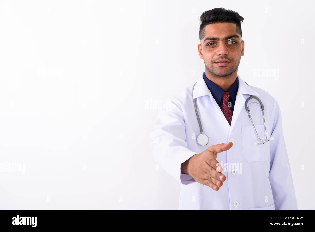 Young Indian man doctor against white background Stock Photo - Alamy