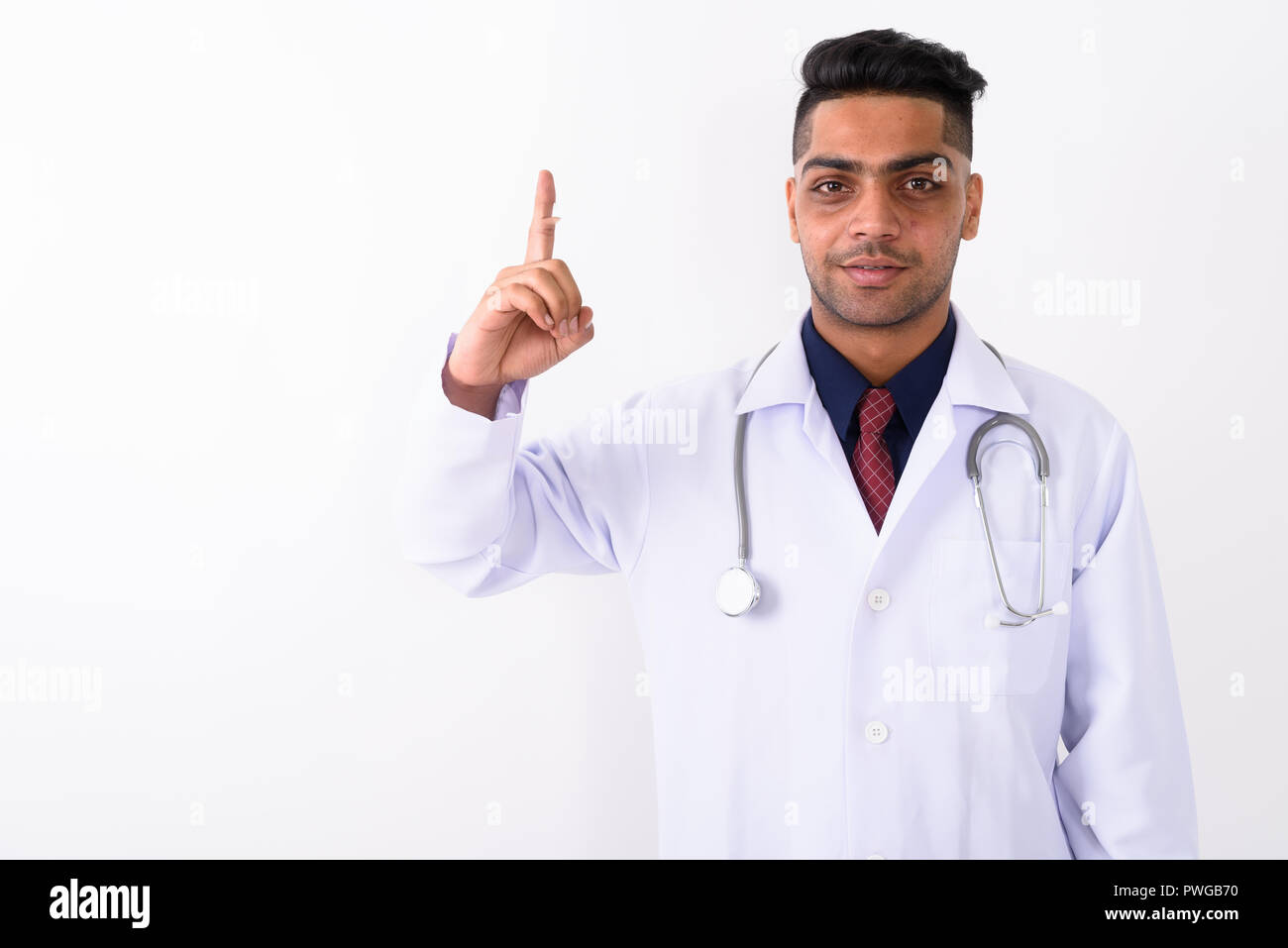 Young Indian man doctor against white background Stock Photo - Alamy