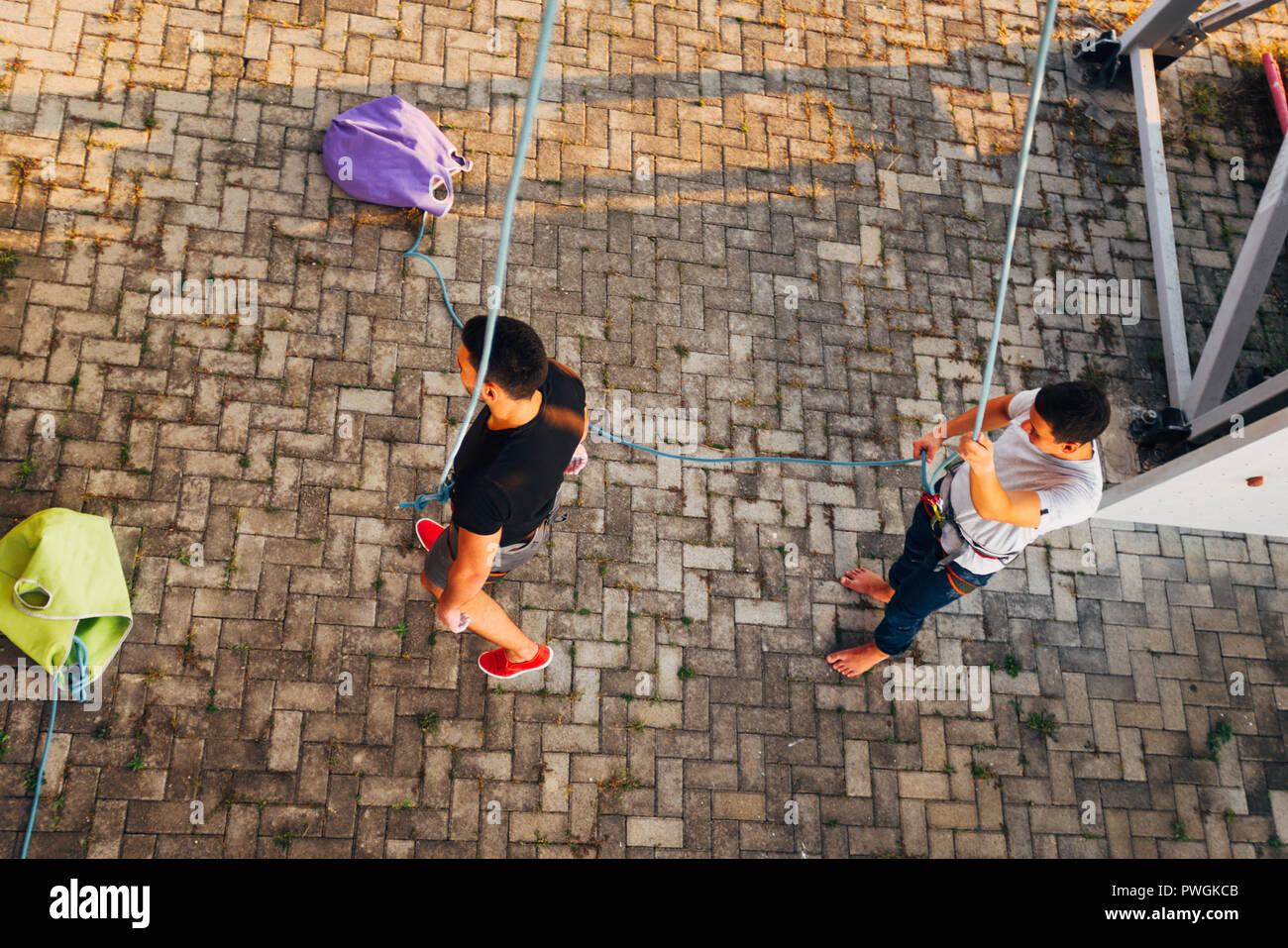 Two man prepare to climbing or bouldering on big wall Stock Photo - Alamy