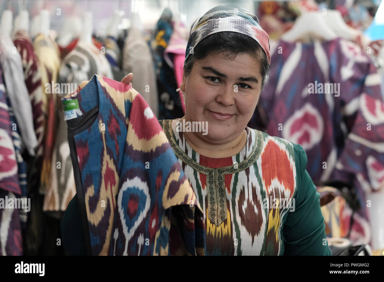 An Uzbek stall holder selling traditional garment in the city of ...