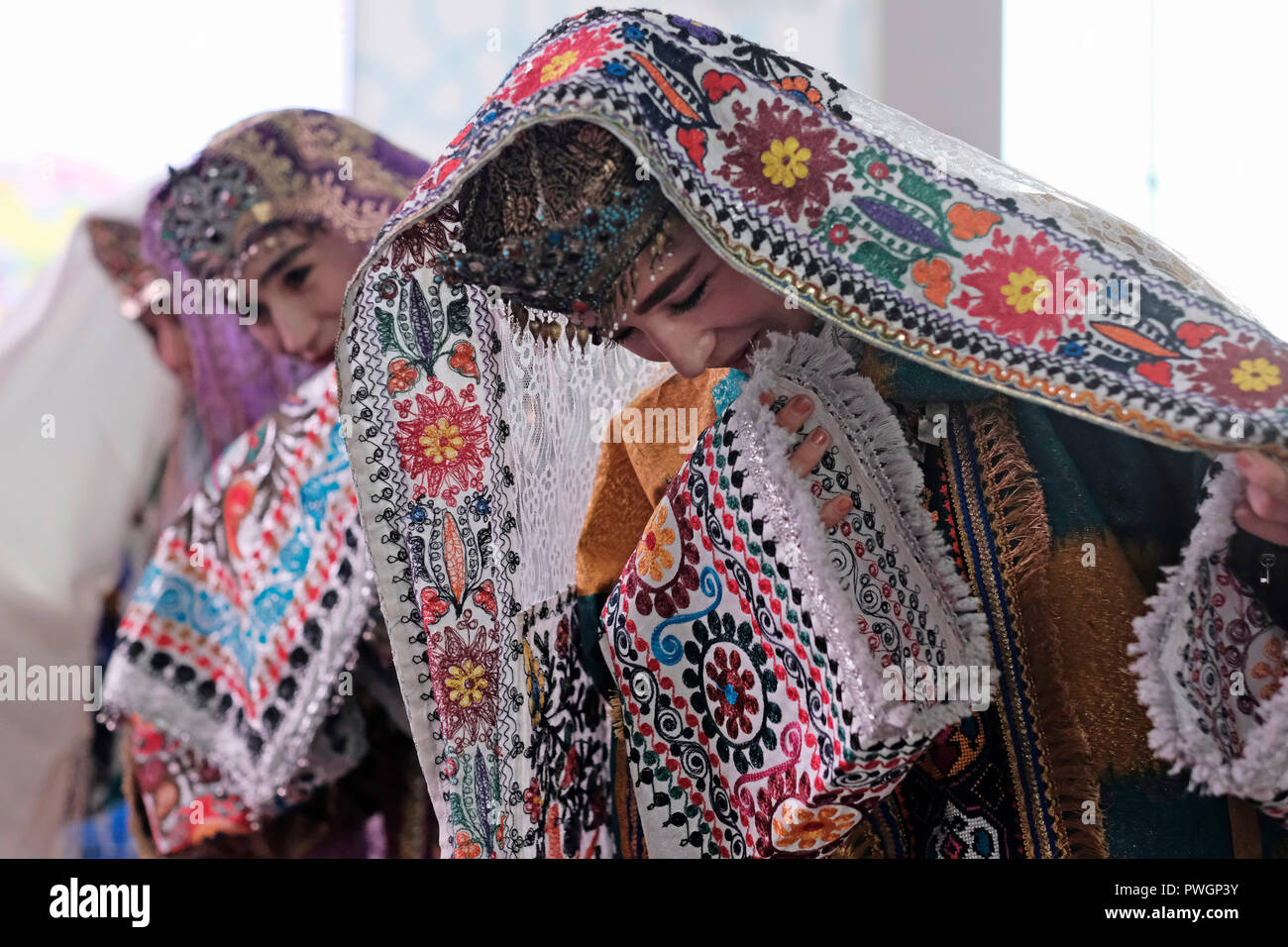 Young Uzbek woman wearing traditional richly embroidered kokoshnik ...