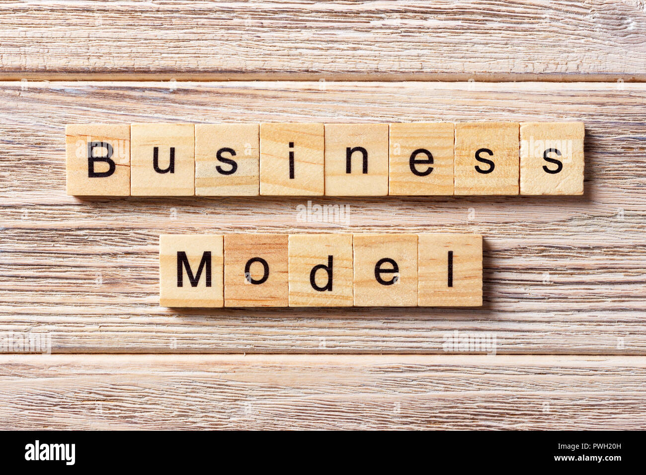 Business model word written on wood block. Business model text on table ...
