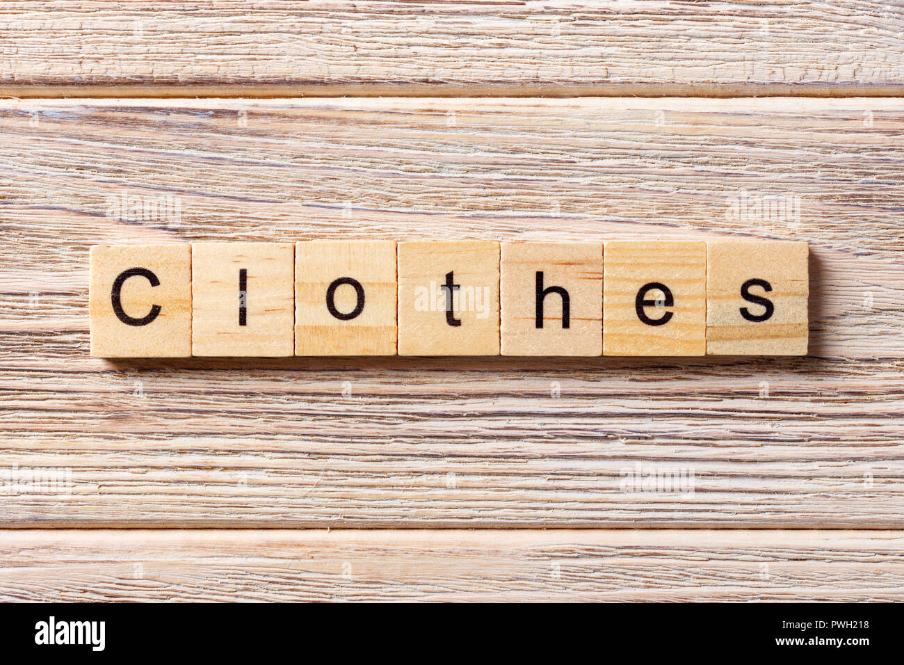 clothes word written on wood block. clothes text on table, concept ...