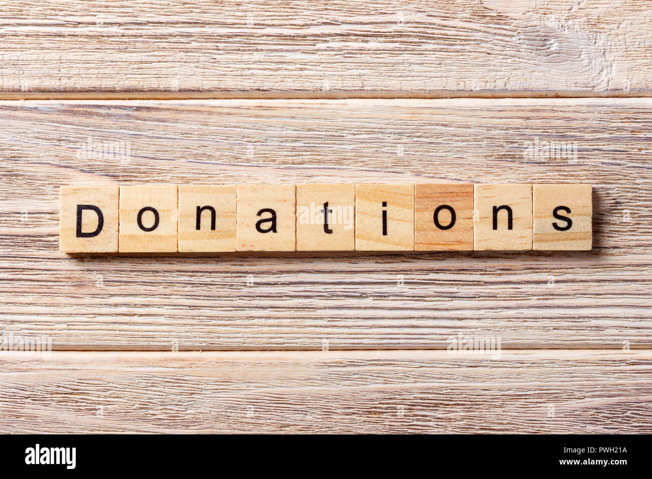 Donation word written on wood block. Donation text on table, concept ...