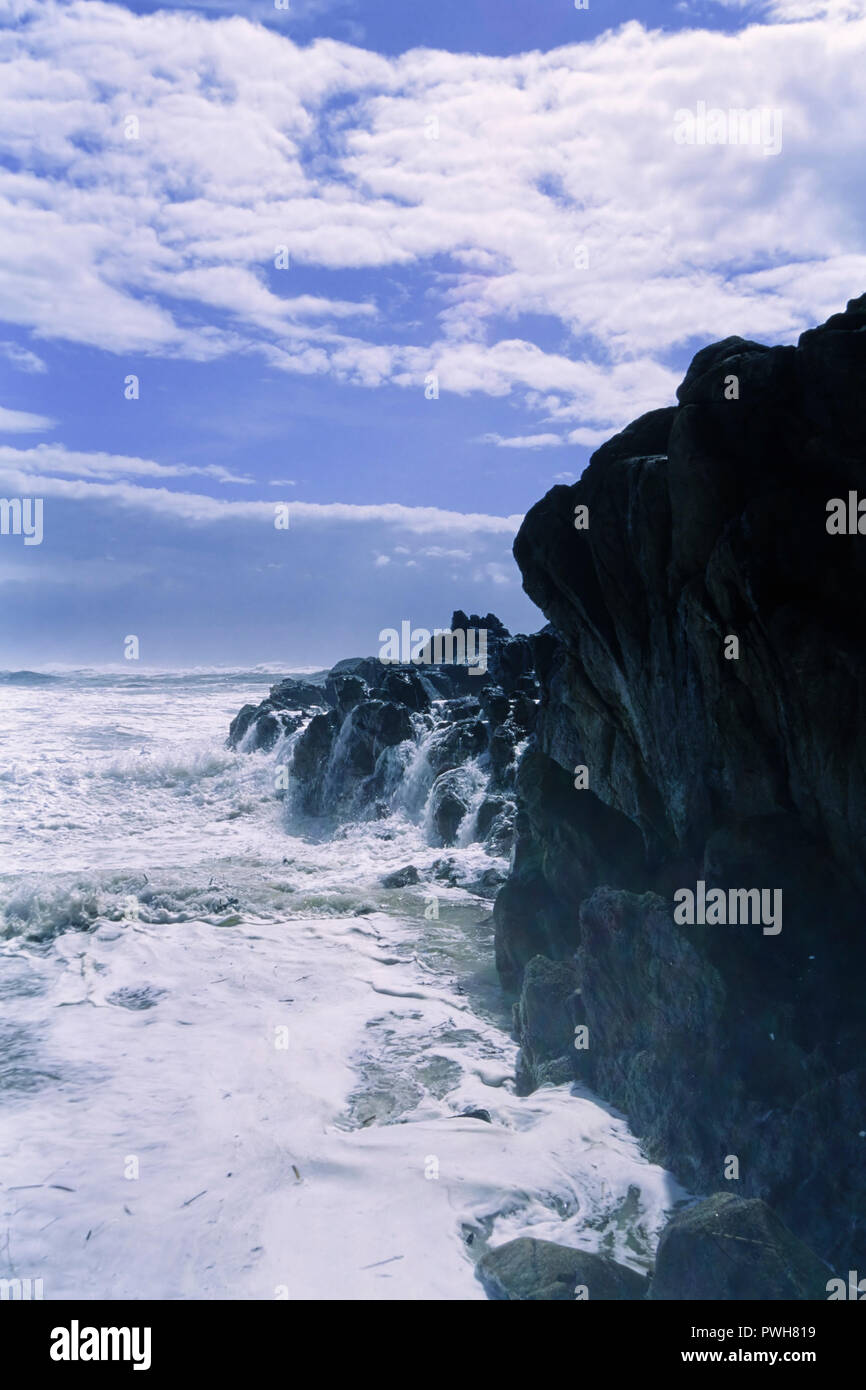 Sea cliff against deep blue sky with white clouds. Soft backlit. ANALOG ...